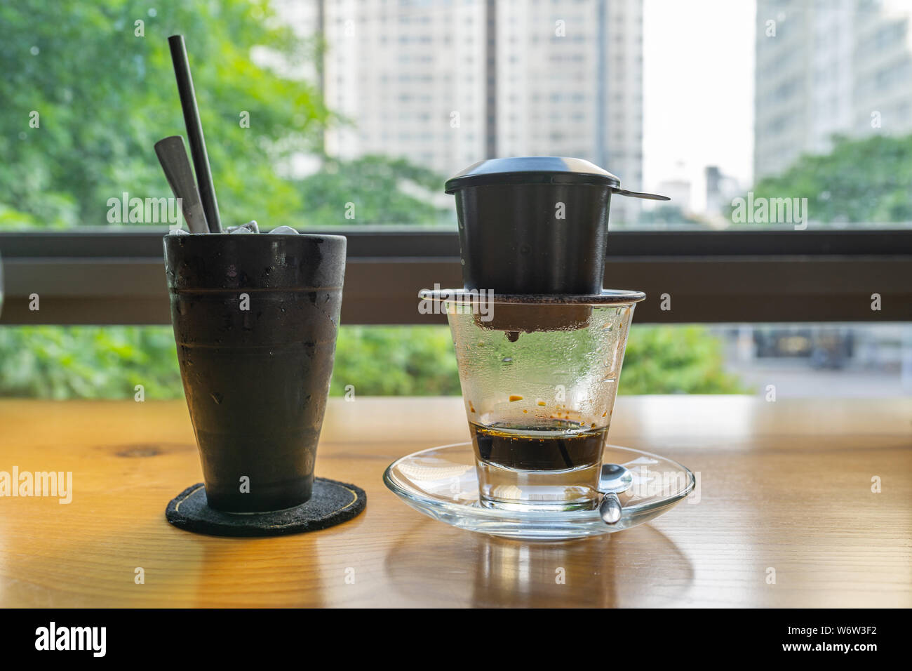Closeup photo of Vietnamese fin coffee with beautiful cityscape view ...