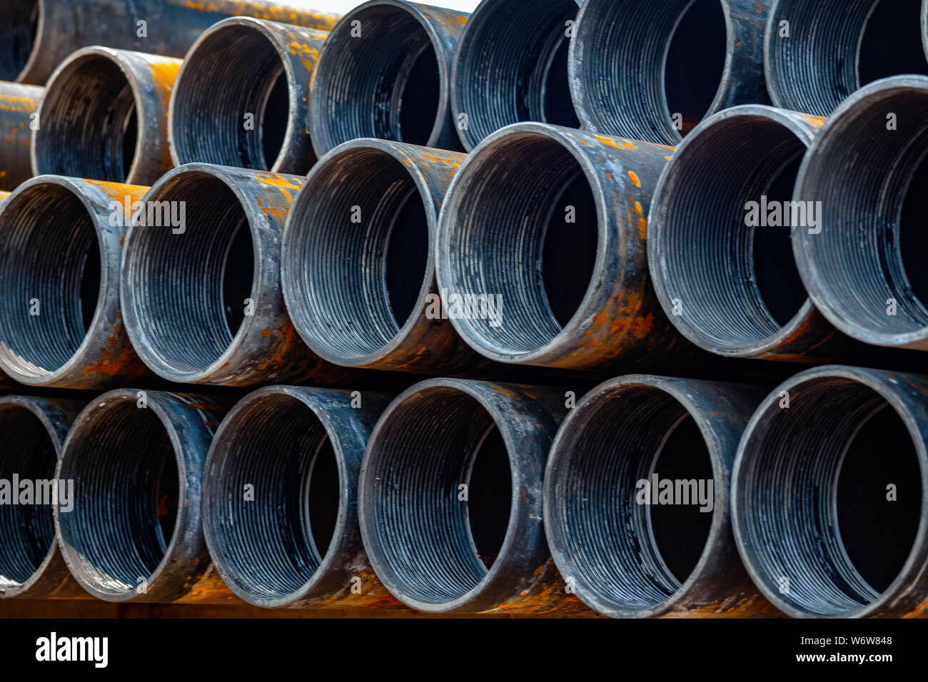 Steel Pipes bunch on the rack in warehouse. Iron pipes at shelf in ...
