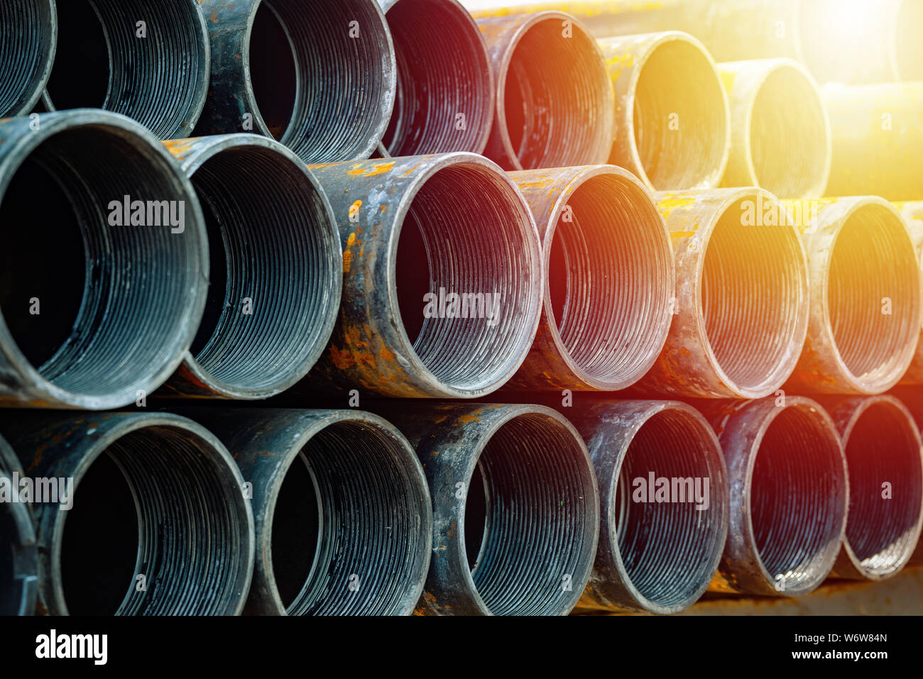 Steel Pipes bunch on the rack in warehouse. Iron pipes at shelf in ...