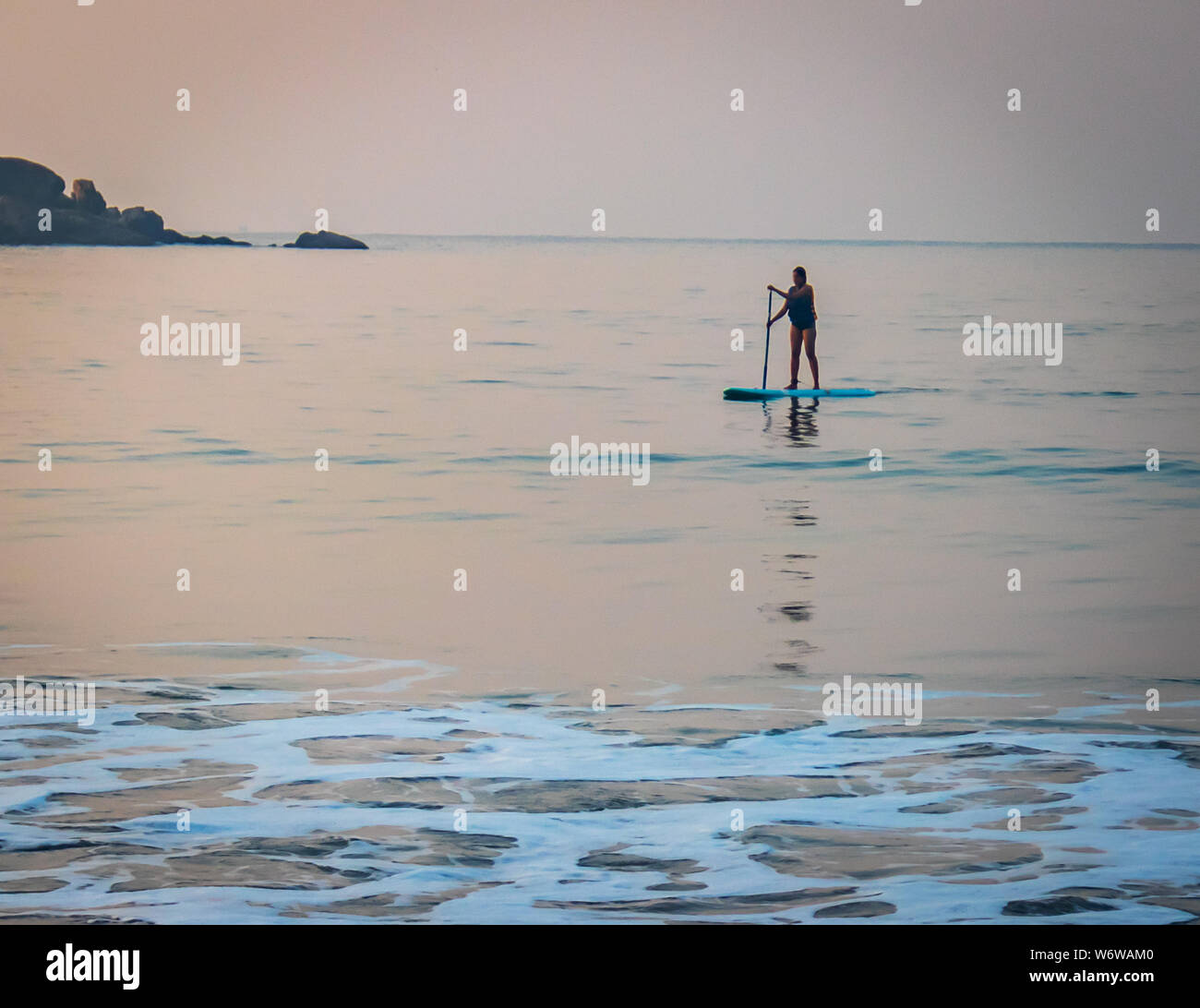 paddle board in the sea in front of a beach.Goa India Stock Photo - Alamy