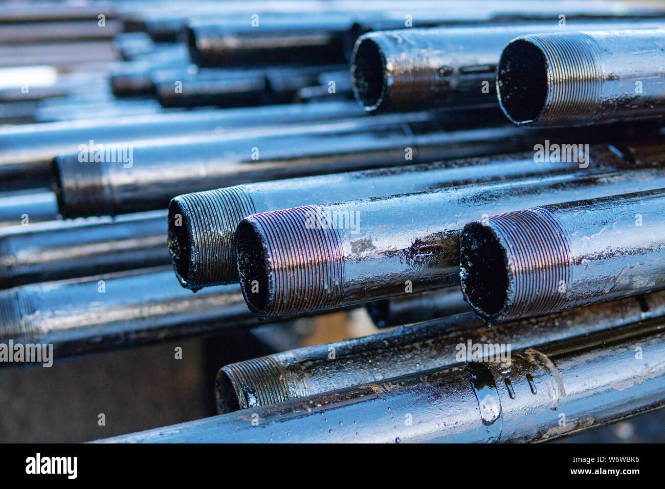 Pipe metal texture. Drillpipe on Oil Rig Pipe Deck. Rusty drill pipes ...