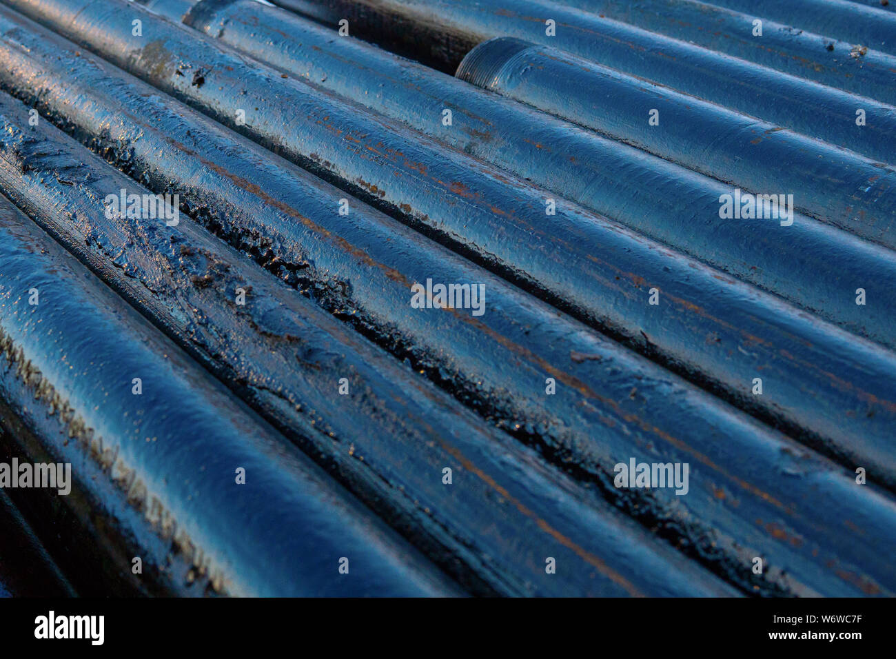 Pipe metal texture. Drillpipe on Oil Rig Pipe Deck. Rusty drill pipes ...