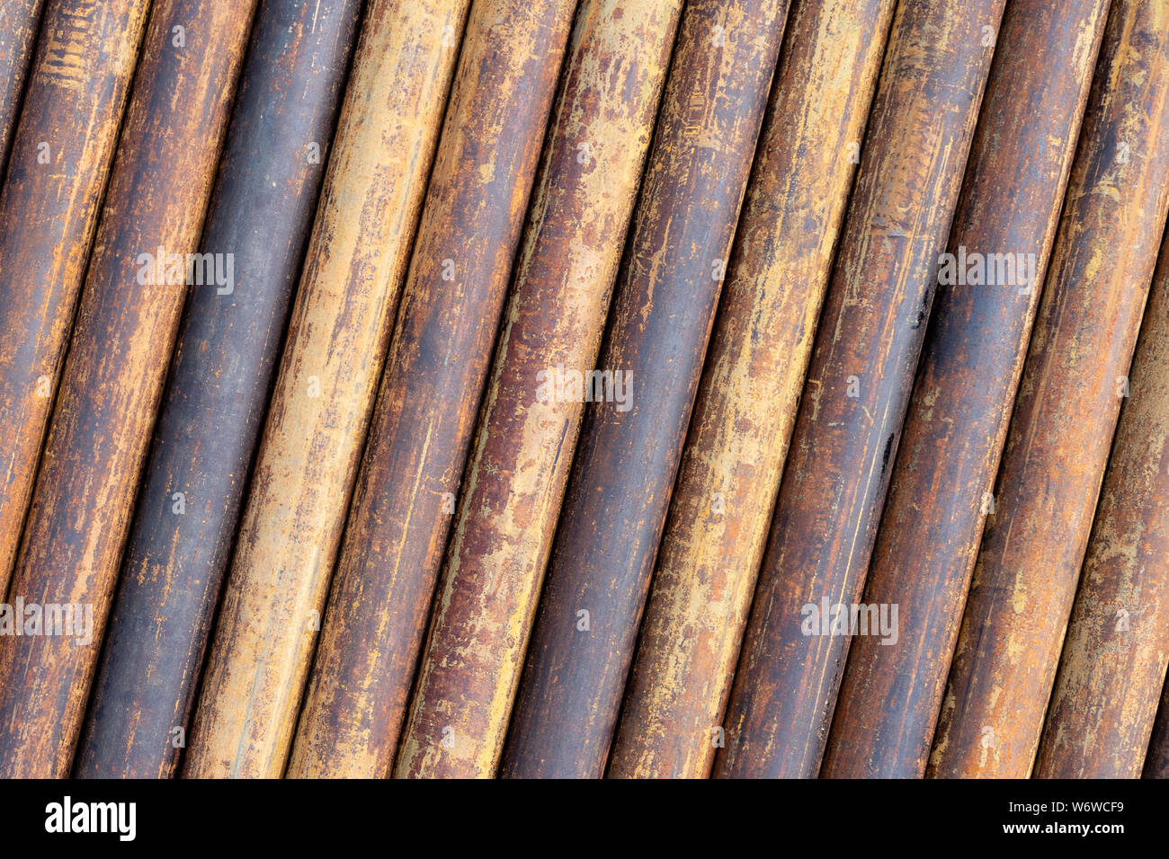 Rusty grunge pipes horizontal background. Orange corrosion rust on ...