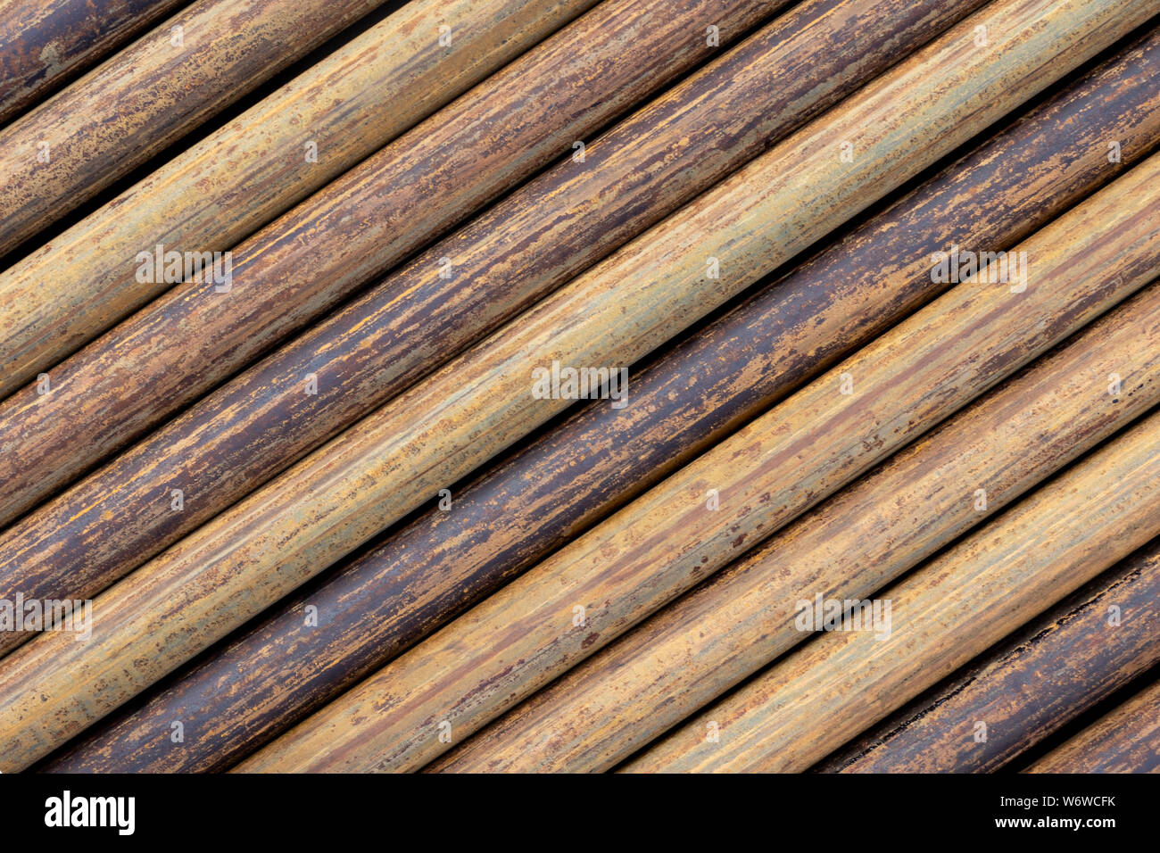 Rusty grunge pipes horizontal background. Orange corrosion rust on ...