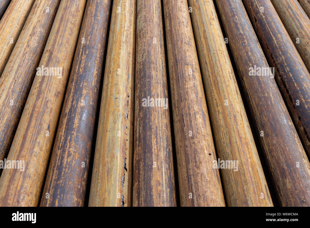Rusty grunge pipes horizontal background. Orange corrosion rust on ...