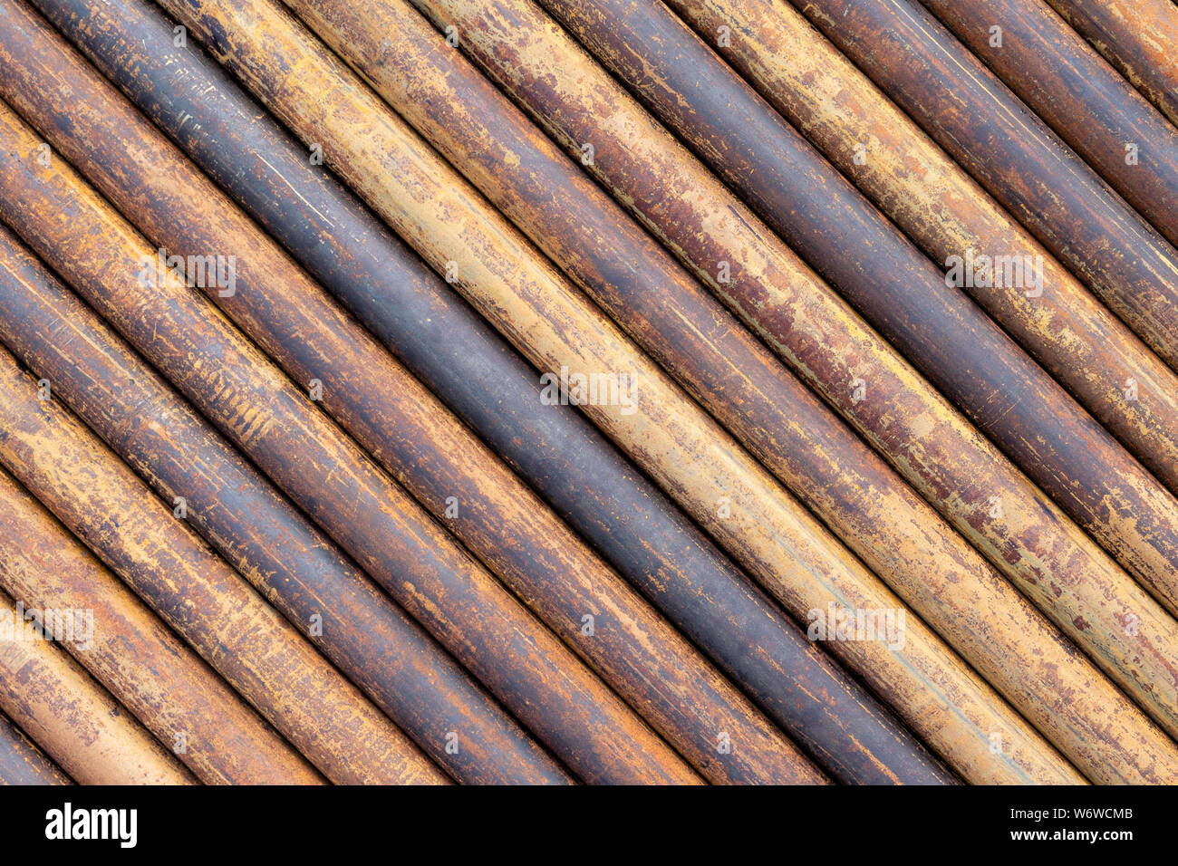Rusty grunge pipes horizontal background. Orange corrosion rust on ...