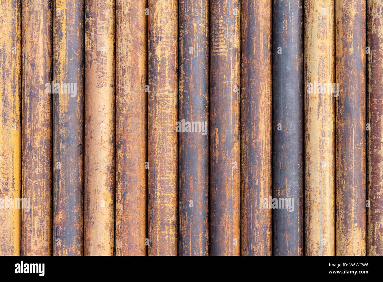 Rusty grunge pipes horizontal background. Orange corrosion rust on ...