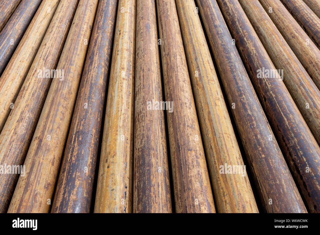 Rusty grunge pipes horizontal background. Orange corrosion rust on ...