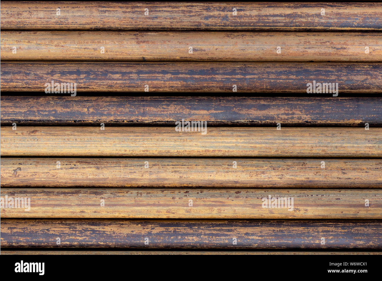 Rusty grunge pipes horizontal background. Orange corrosion rust on ...