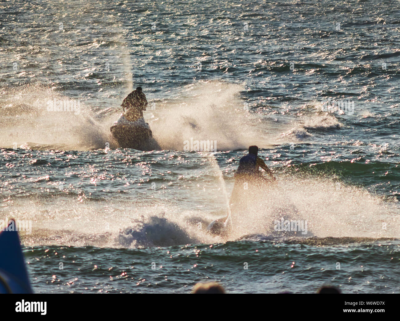 Young couple riding a jet ski / wave runner in Goa sea, wearing safety ...
