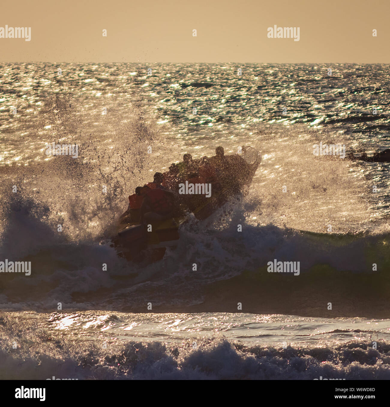 Young couple riding a jet ski / wave runner in Goa sea, wearing safety ...