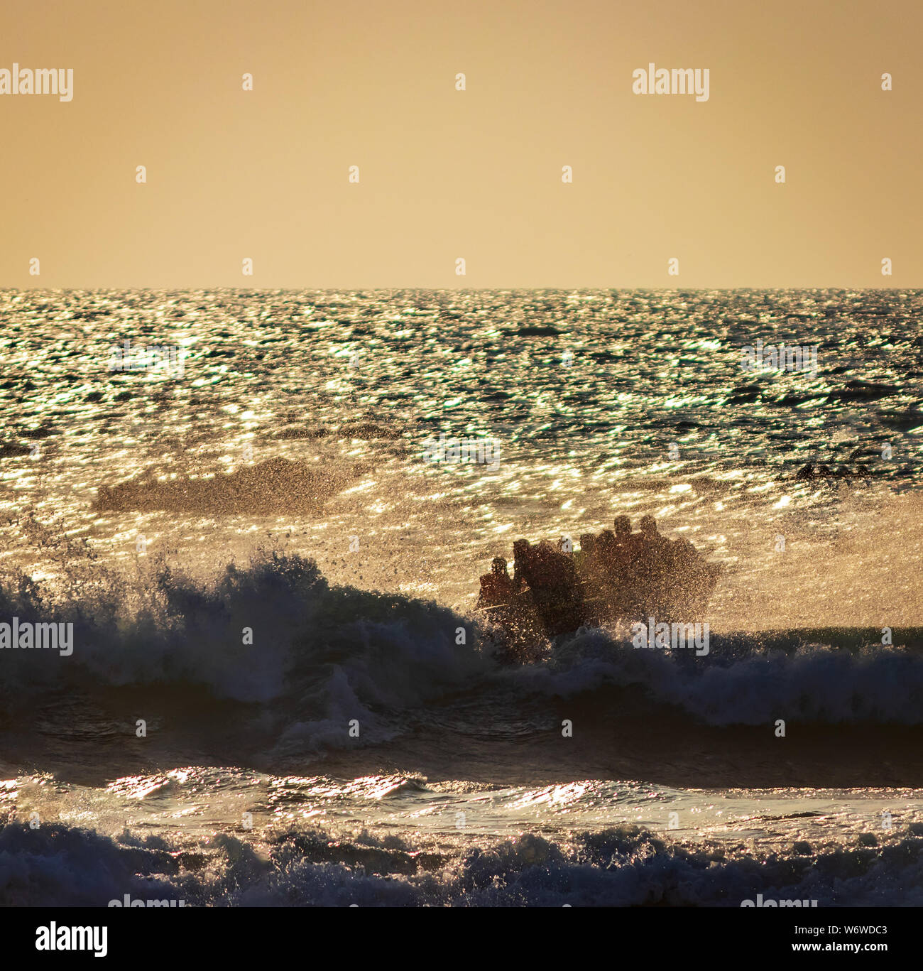 Young couple riding a jet ski / wave runner in Goa sea, wearing safety ...