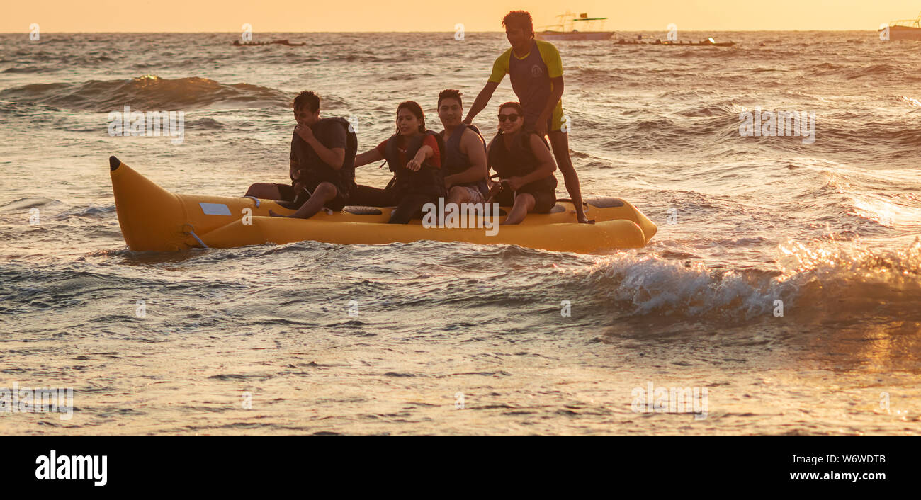 Young couple riding a jet ski / wave runner in Goa sea, wearing safety ...