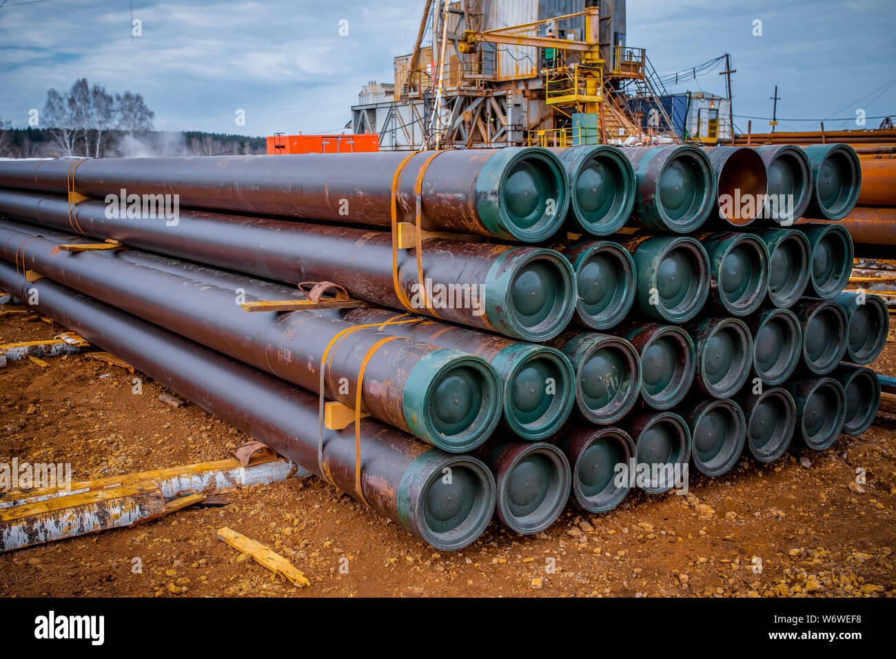 Stacked steel pipe with sunlight reflecting on the interior walls ...