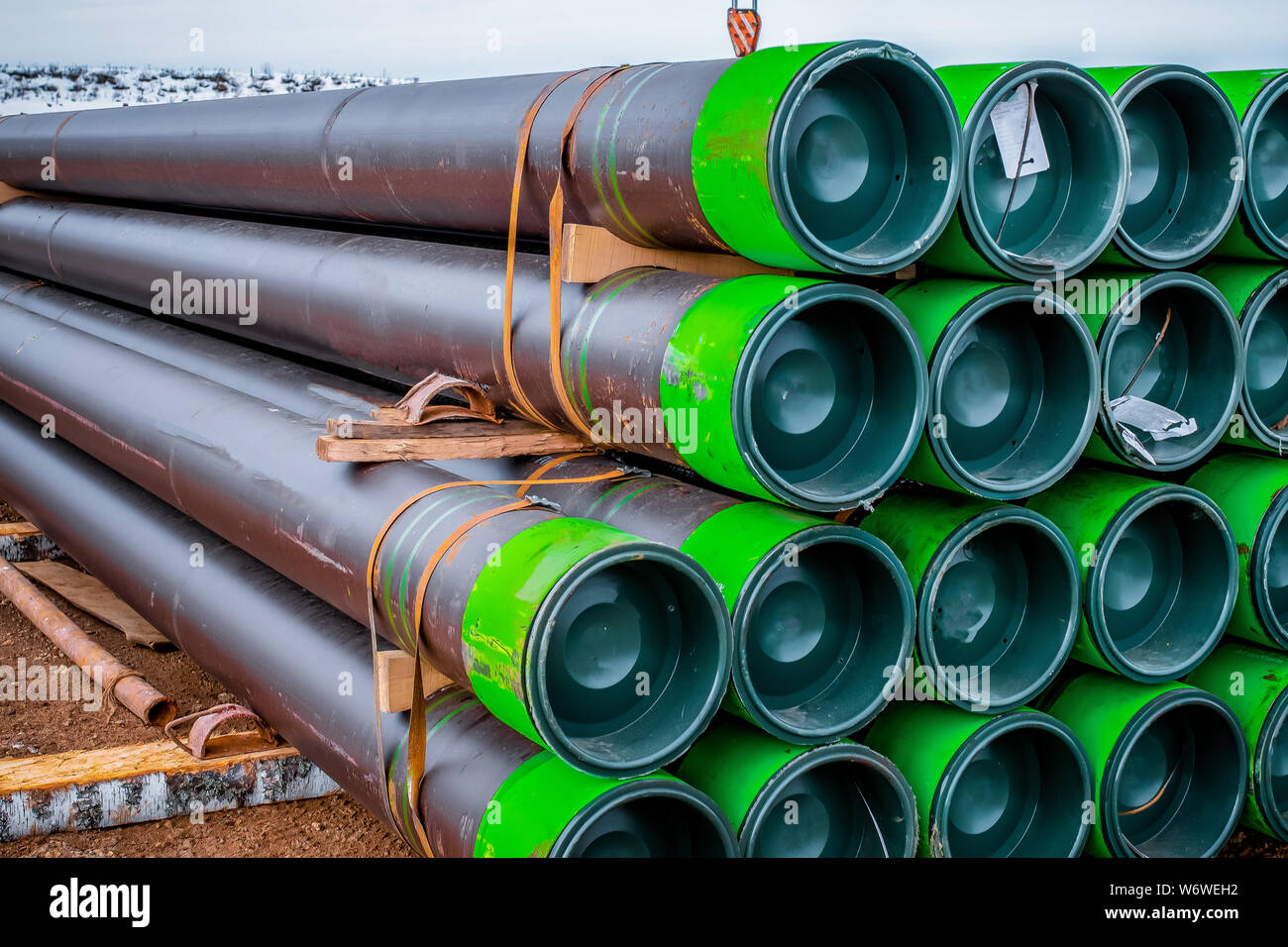 Stacked steel pipe with sunlight reflecting on the interior walls ...