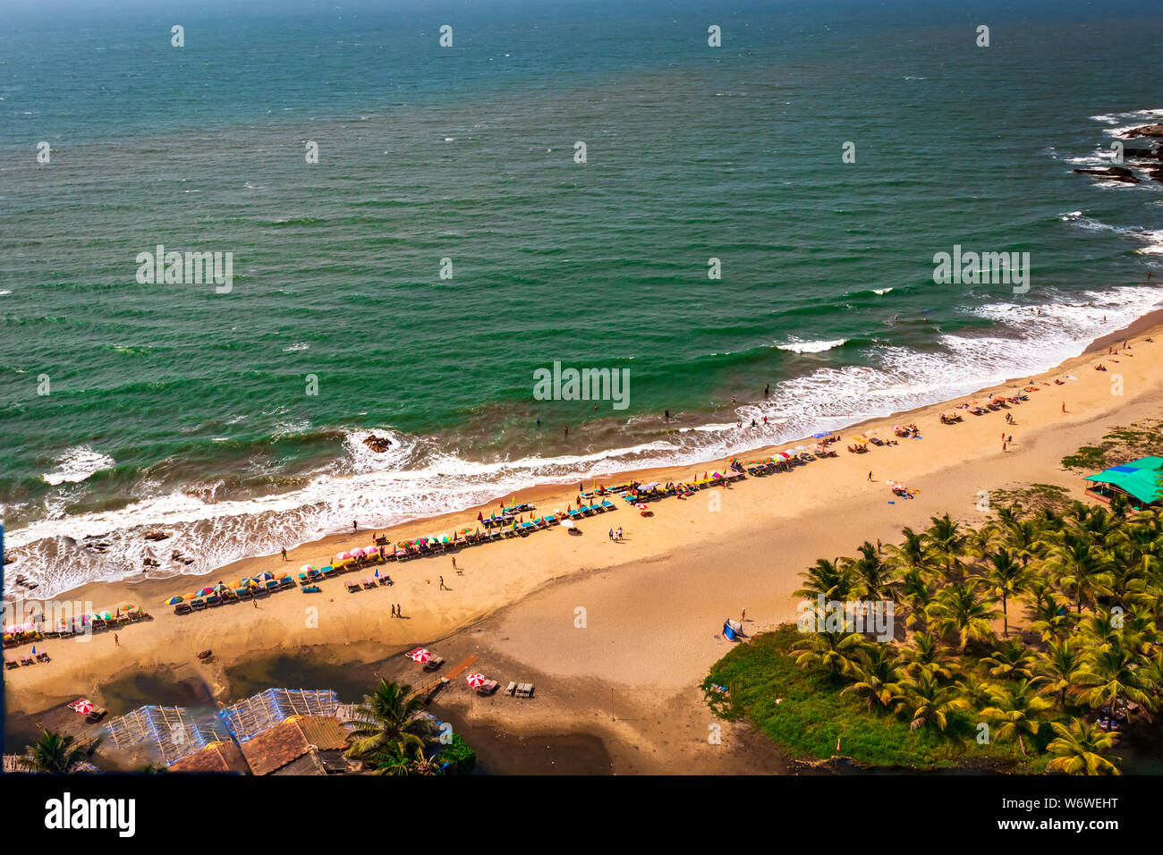 top view of beach in Goa India vagator beach. people taking sunbath on ...