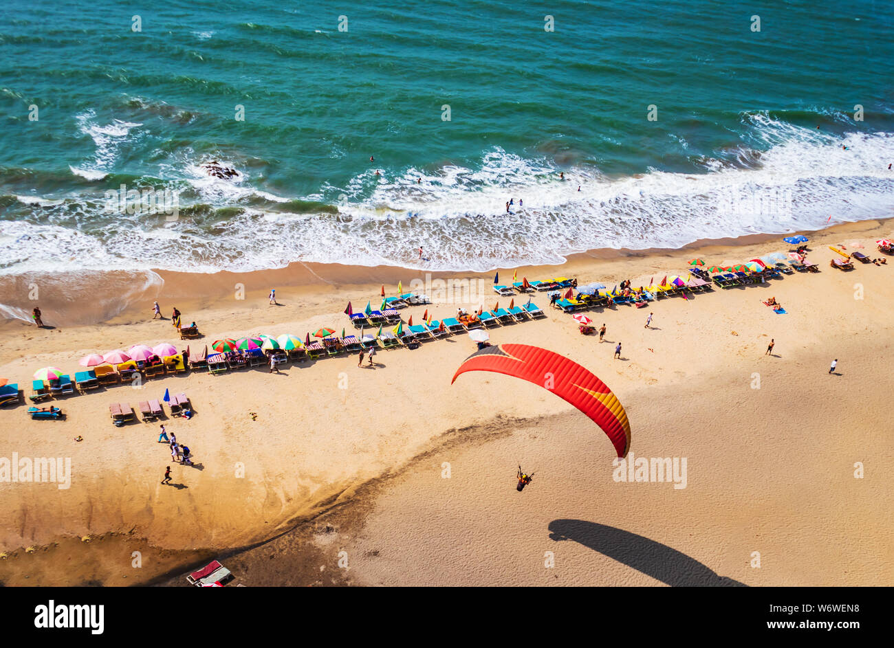 Paragliding in the sky. Paraglider tandem flying over the sea with blue ...