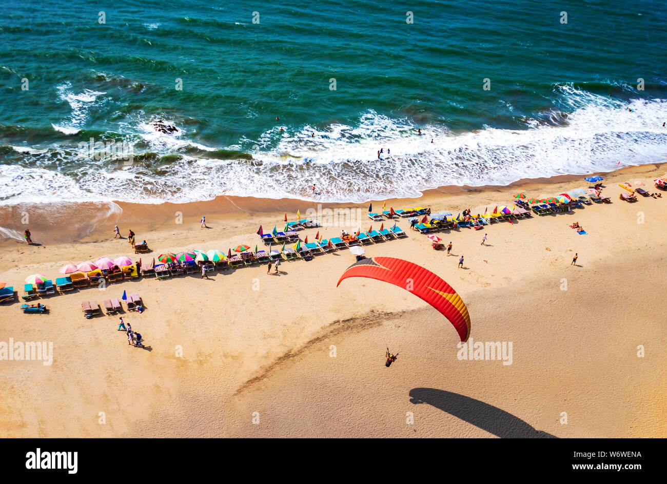 Paragliding in the sky. Paraglider tandem flying over the sea with blue ...