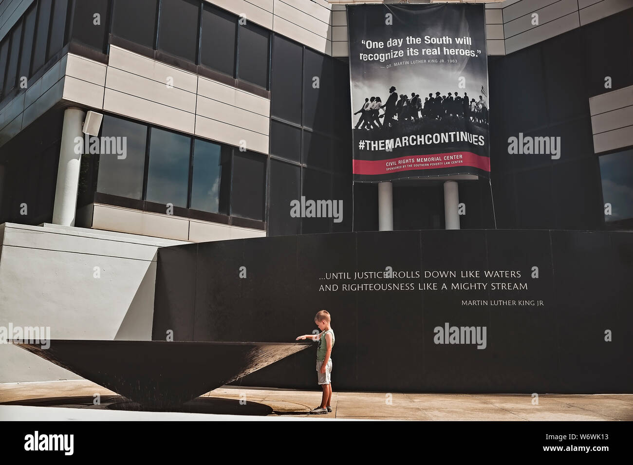 A photograph of a child standing at theThe Civil Rights Memorial ...