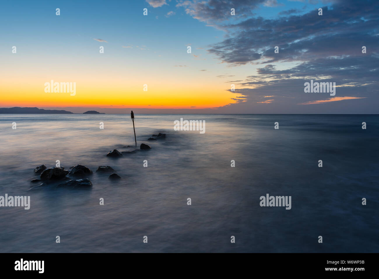 Magic sunset sky over endless flat blue ocean water Stock Photo - Alamy