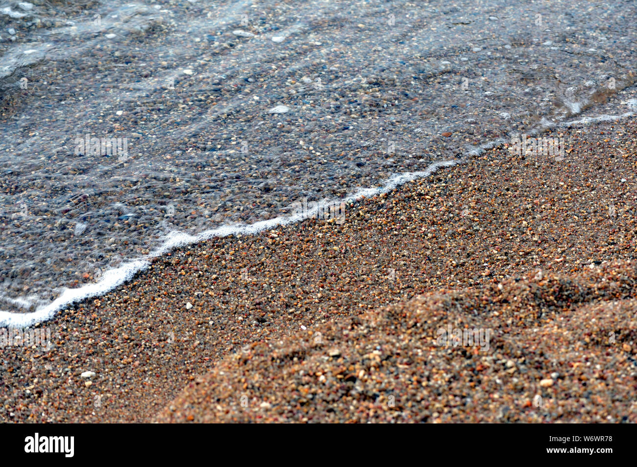Sea water and beach sand close-up. Natural background Stock Photo - Alamy