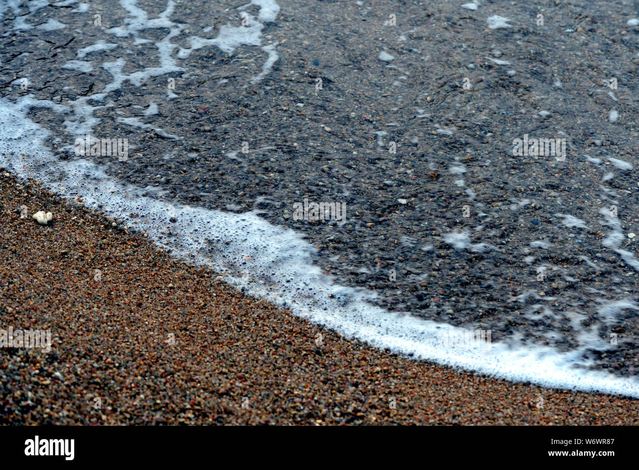 Sea water and beach sand close-up. Natural background Stock Photo - Alamy