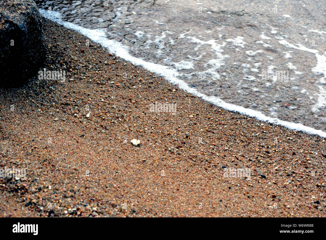 Sea water and beach sand close-up. Natural background Stock Photo - Alamy
