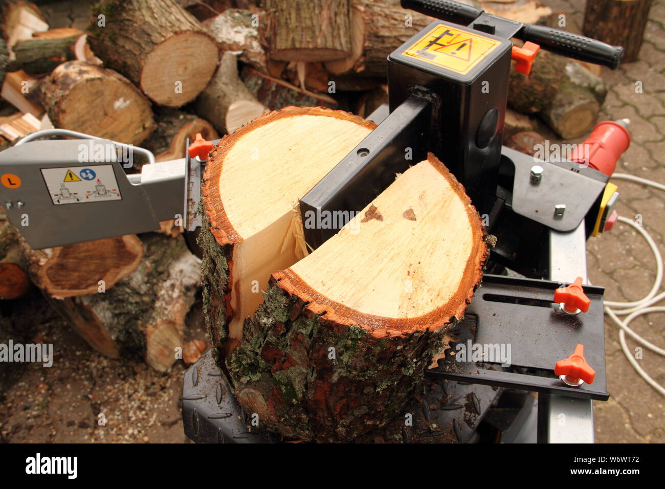 wood splitters with firewood Stock Photo - Alamy