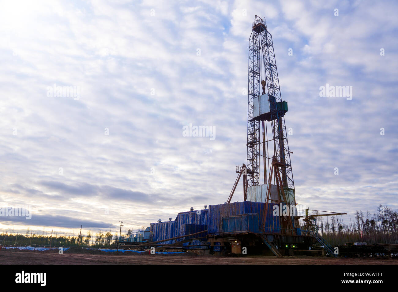 Oil and Gas Drilling Rig onshore dessert with dramatic cloudscape. Oil ...