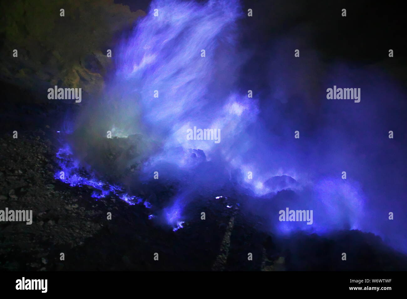 The blue fire in fog at night on Ijen volcano, Indonesia Stock Photo ...
