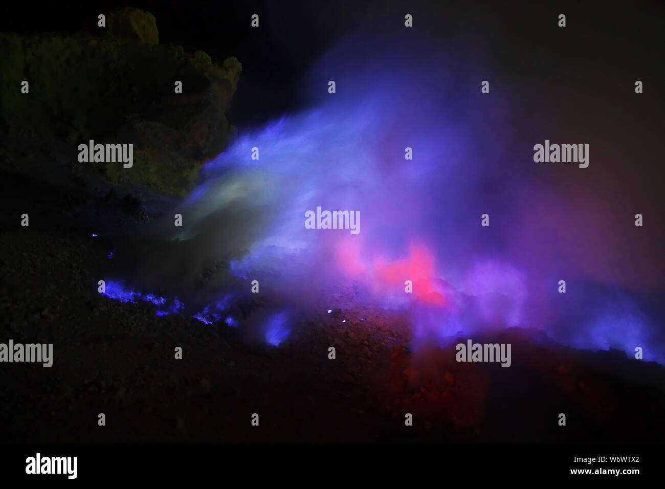 The blue fire in fog at night on Ijen volcano, Indonesia Stock Photo ...