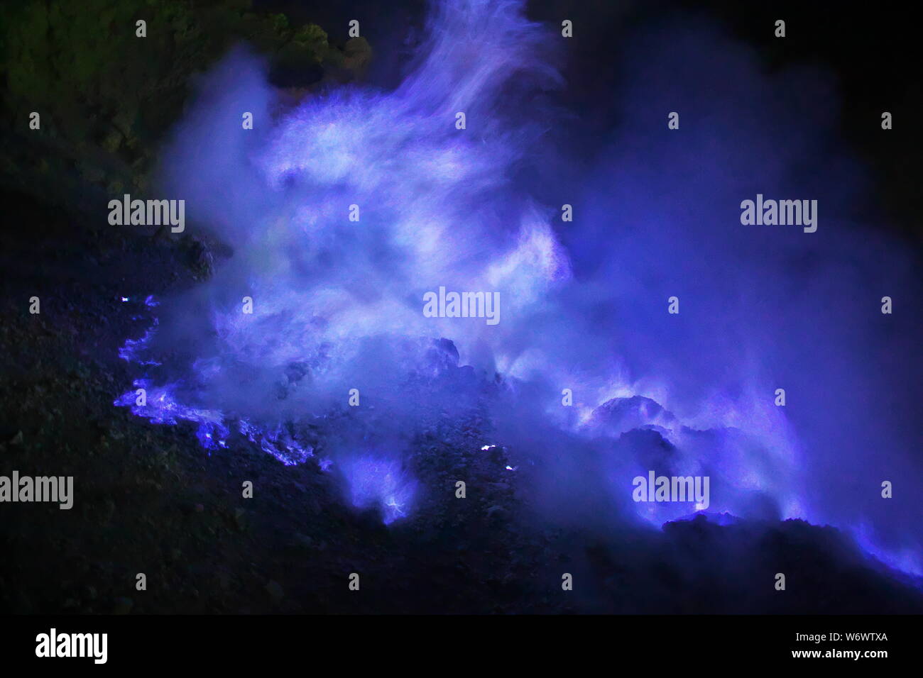 The blue fire in fog at night on Ijen volcano, Indonesia Stock Photo ...
