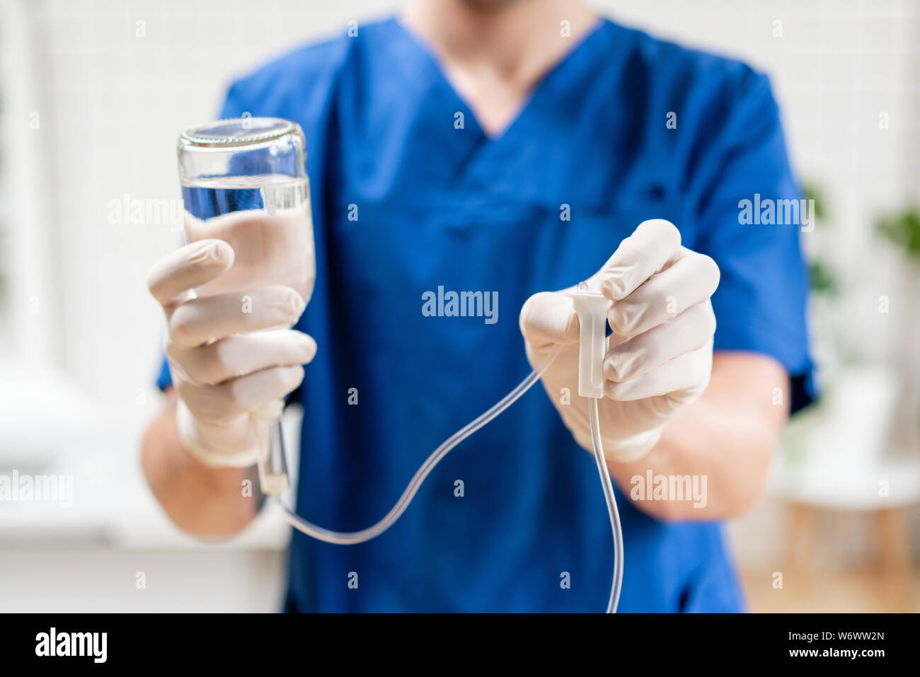 Medical treatment emergency concept. Doctor holding drip and adjust ...