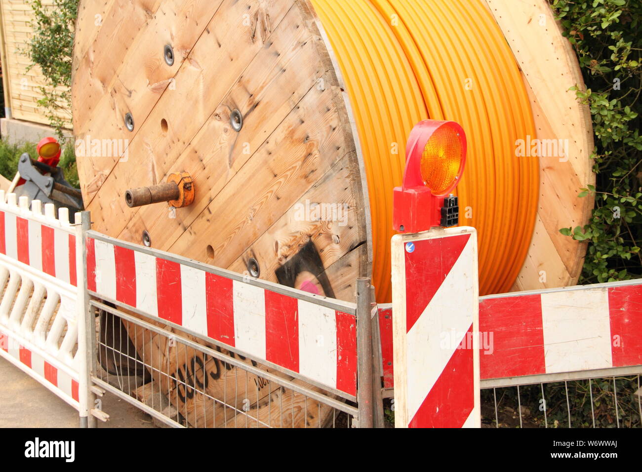 orange fiber optic cable on the street Stock Photo - Alamy
