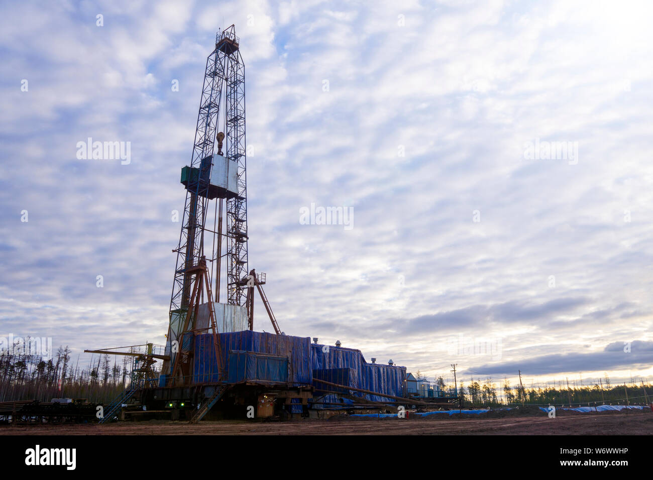 Oil and Gas Drilling Rig onshore dessert with dramatic cloudscape. Oil ...