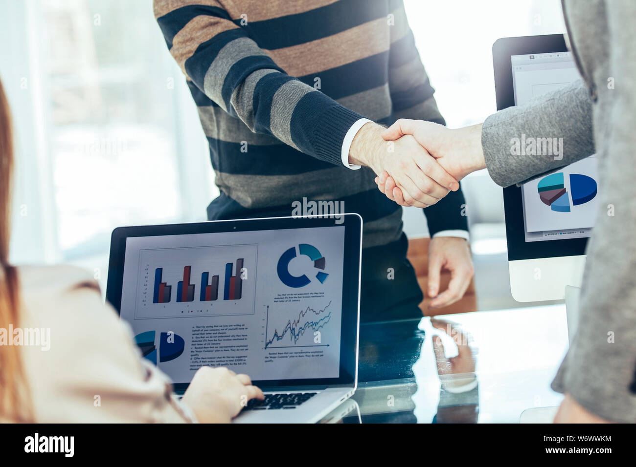 handshake between the client and the Manager of the company near the ...