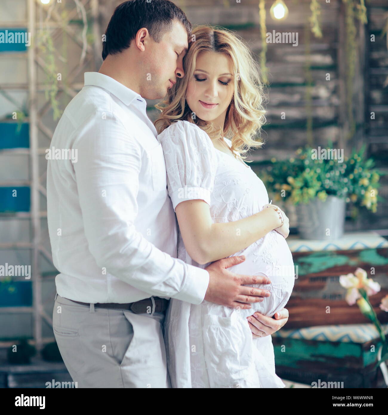 happy husband and pregnant wife in cafe tenderly hugging and holding ...