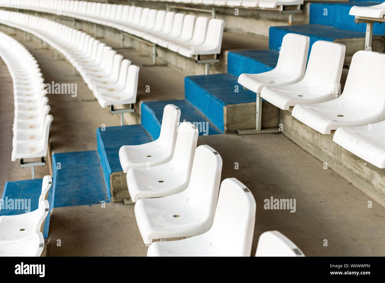 White stadium seats with stairs. Soccer, football or baseball stadium ...