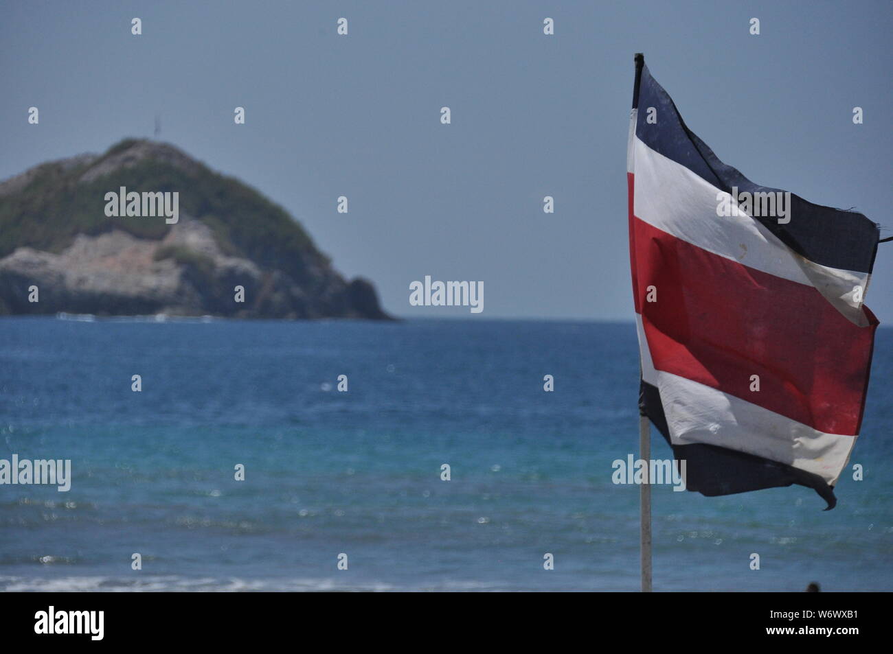 Flag of Costa Rica fluttering in the wind over the Pacific coast Stock ...