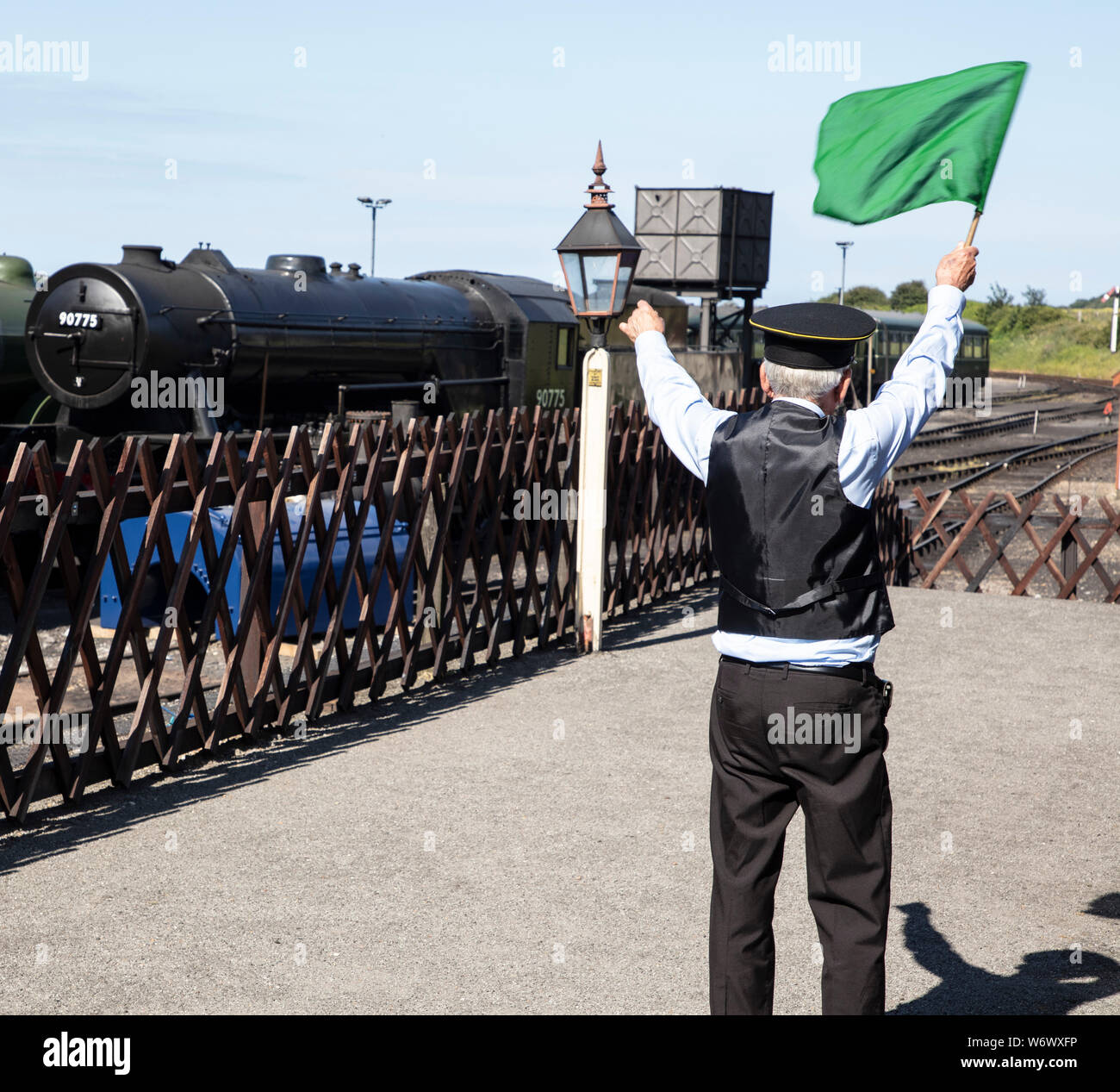 Station Master waving flag on North Norfolk Steam Railway Stock Photo ...