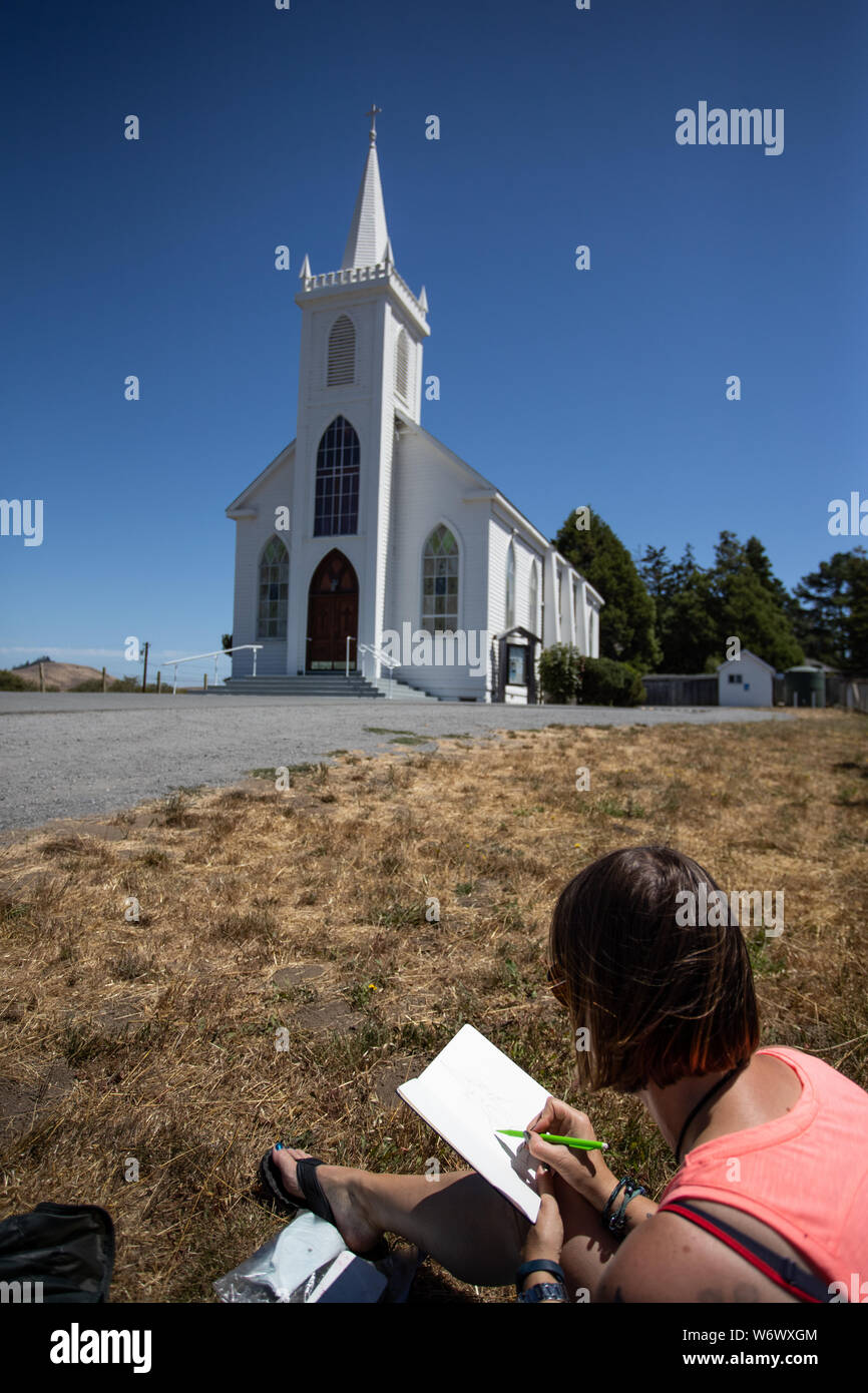 A lone artist sits and sketches St Teresa of Avila. This is the church ...
