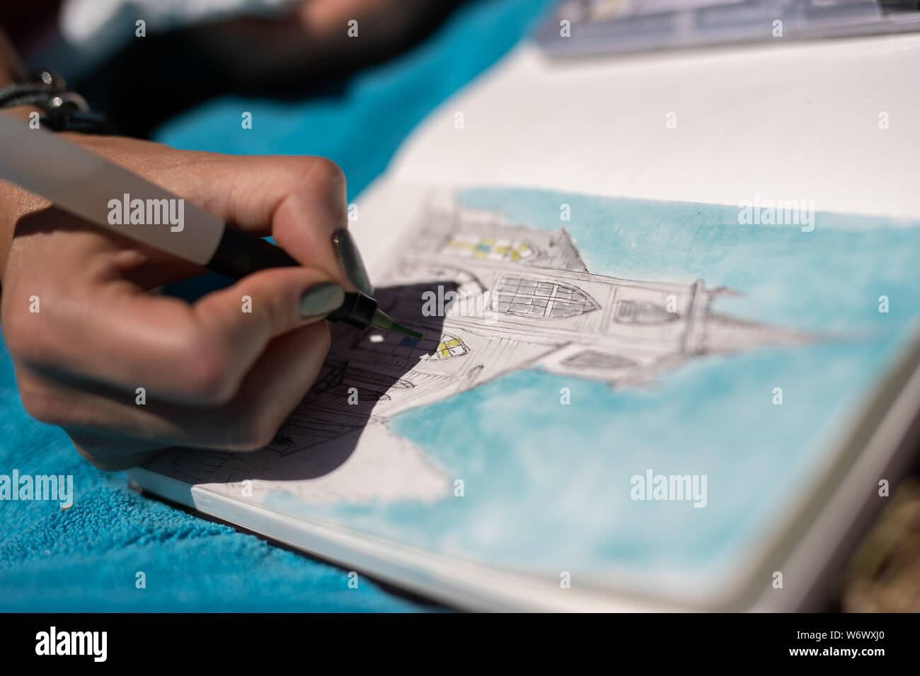 A lone artist sits and sketches St Teresa of Avila. This is the church ...