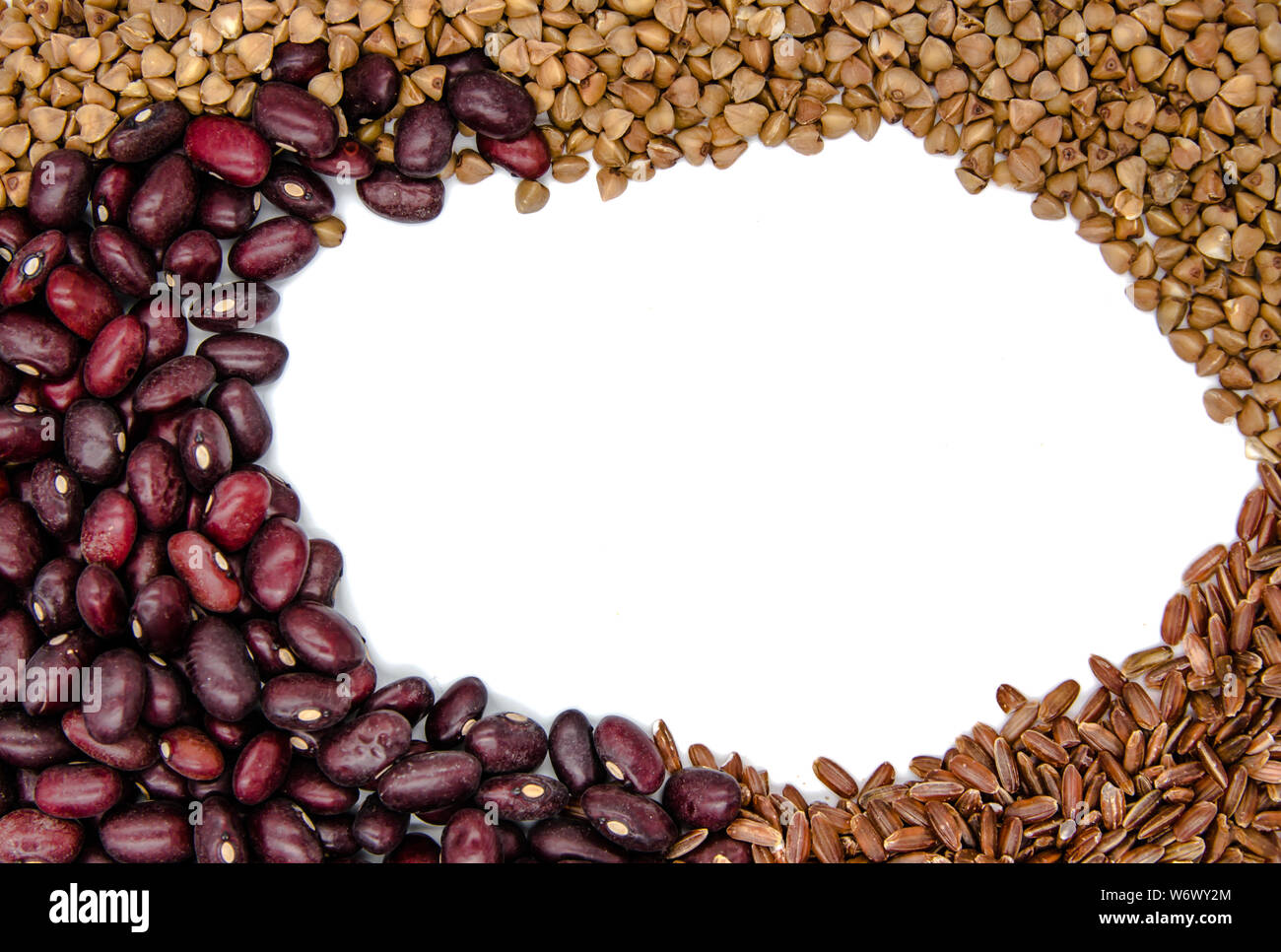 red beans, brown ruby rice and buckwheat on a white background with ...