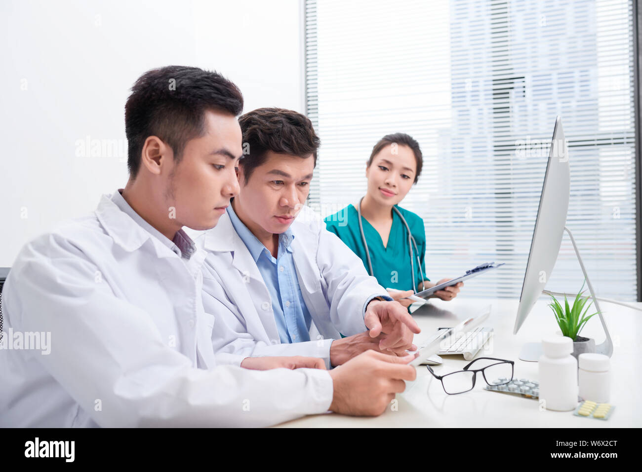 Doctor nurse looking computer monitor hi-res stock photography and ...