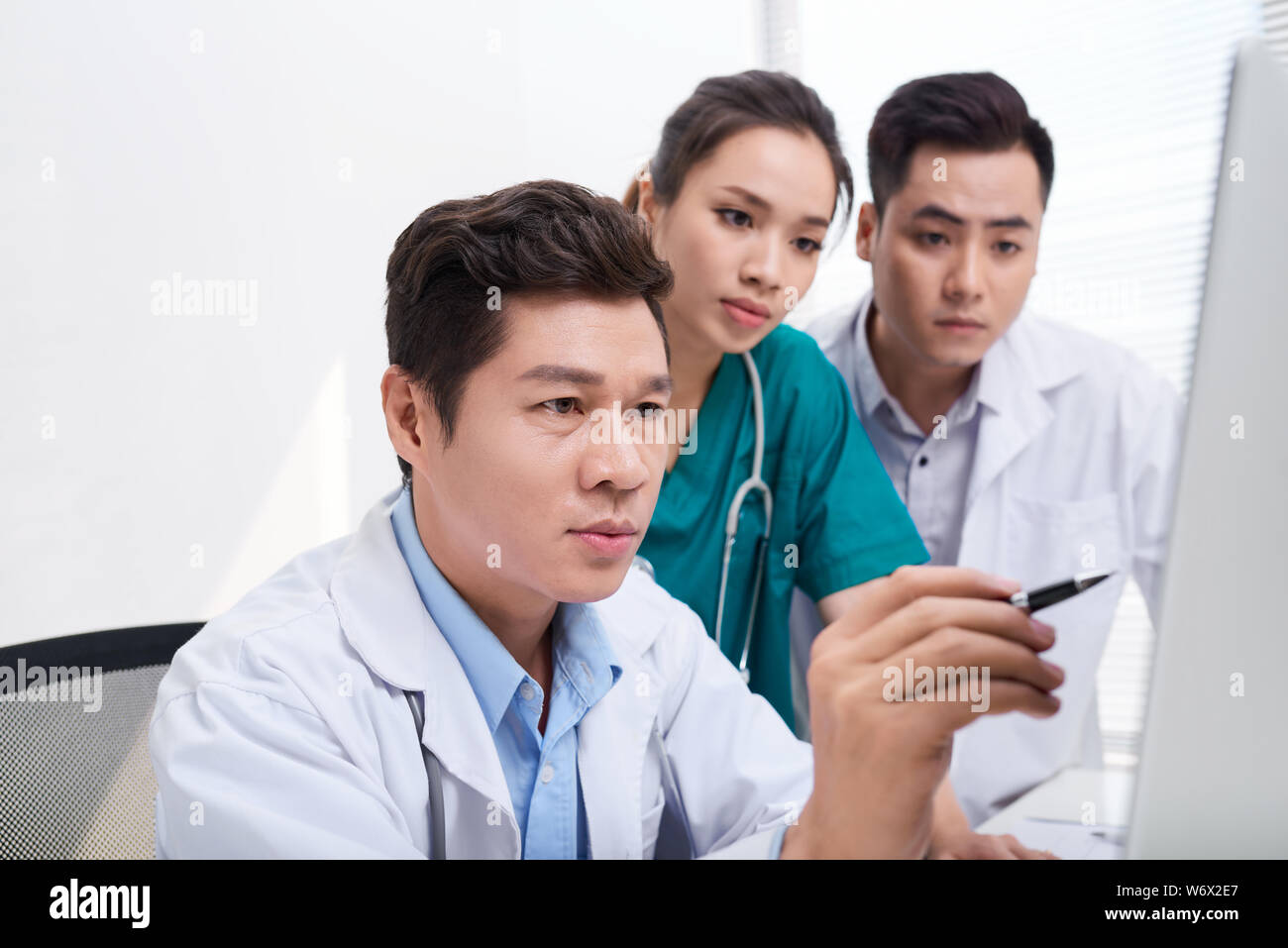 Team of doctors working and having on laptop in medical office Stock ...