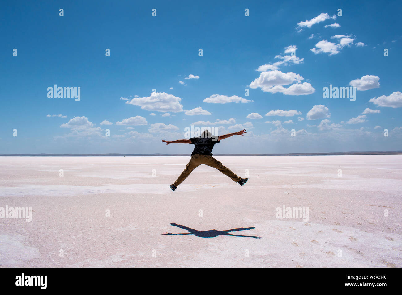 Young man jumping, sky, clouds hi-res stock photography and images - Alamy