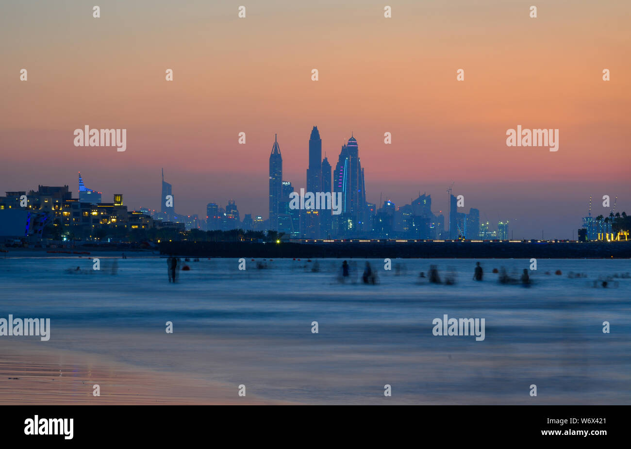 Dubai, UAE - Dec 7, 2018. Sunset on the sand beach near Burj al-Arab ...