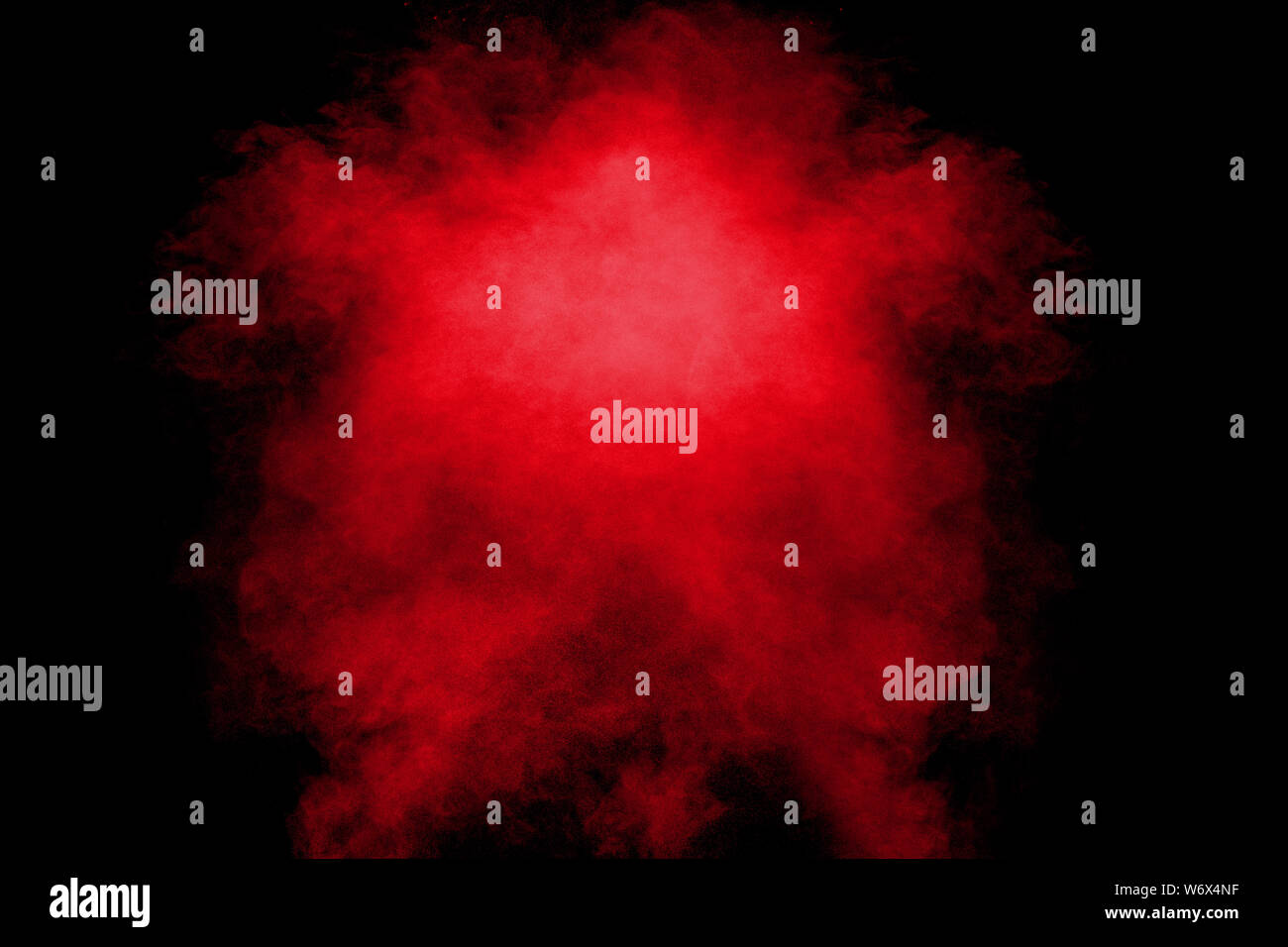 Red orange color powder explosion cloud on black background Stock Photo ...