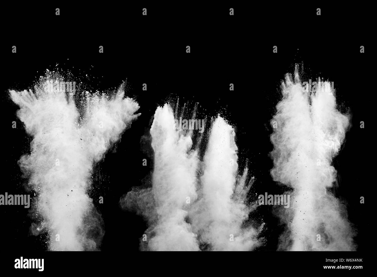 White talcume powder explosion on black background. White dust ...