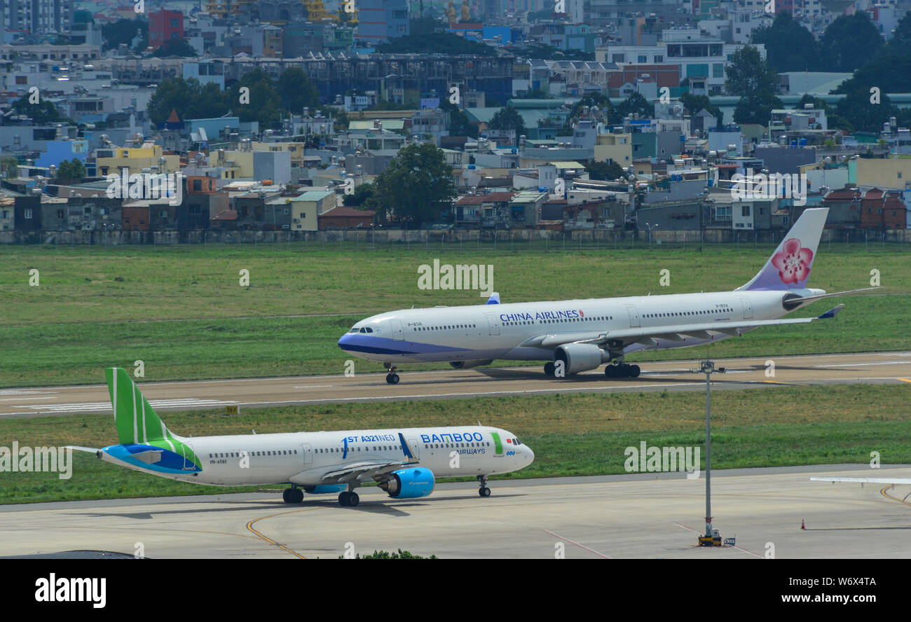 Saigon, Vietnam - Jul 13, 2019. Passenger airplanes taxiing on runway ...